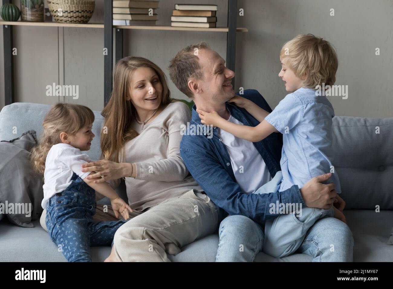 Joyful two generations family playing at home Stock Photo - Alamy