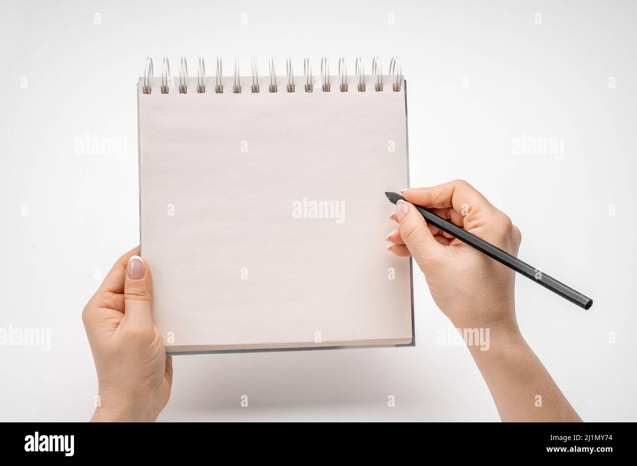 female hands writing in mockup notepad isolated on white. Woman writing ...