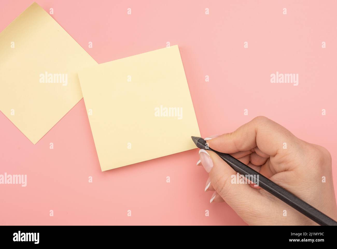 woman hand writing on yellow sticky notes. Hand written notes black ...