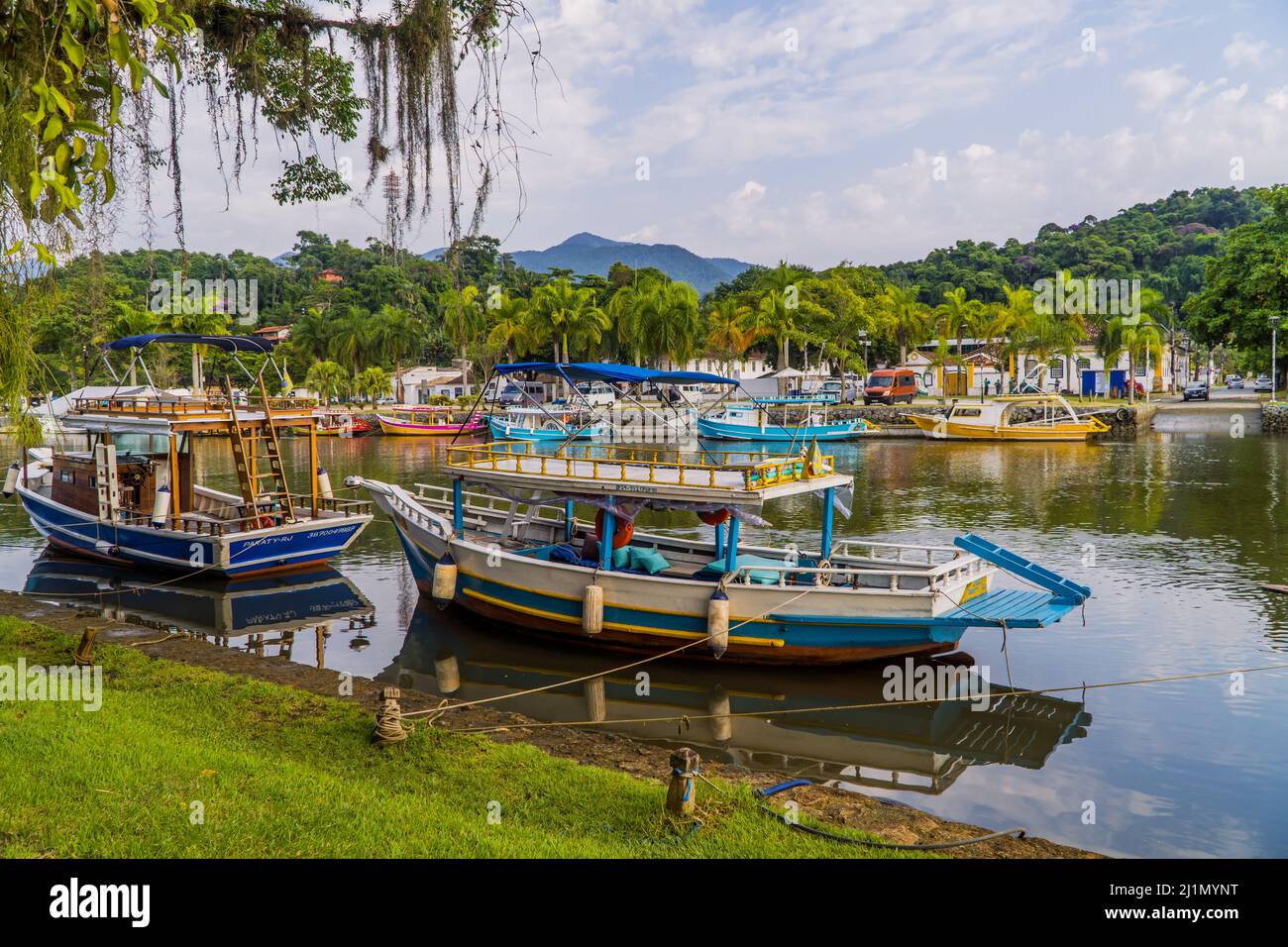 A scenery of small tourist boats in the main port of Paraty with ...