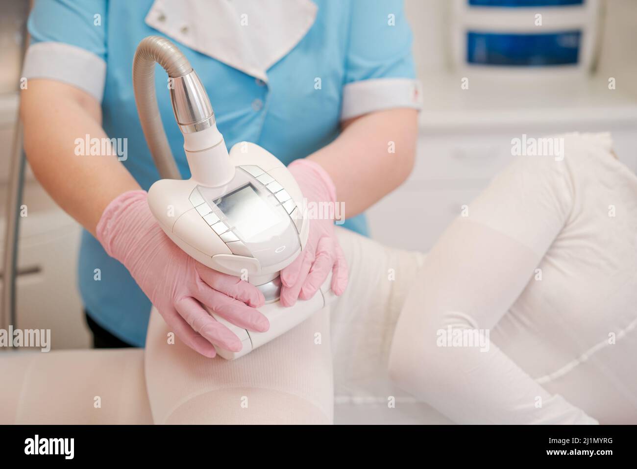 Young woman in white suit undergoing LPG beauty massage, close-up ...