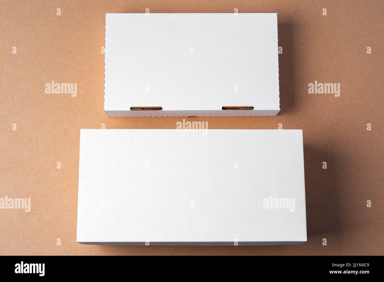 Cardboard box on beige background in studio Stock Photo - Alamy