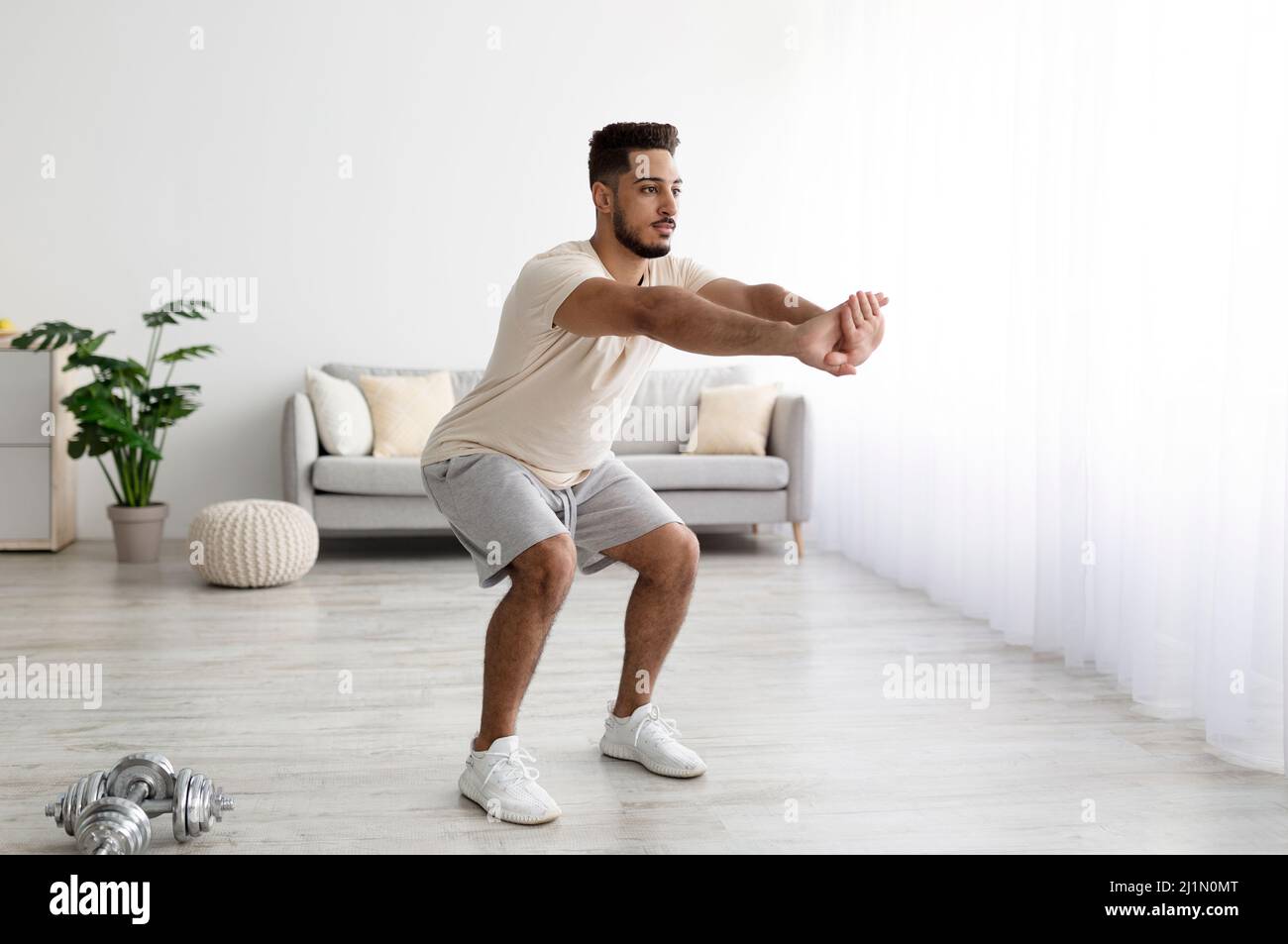 Handsome muscular man exercise squats hi-res stock photography and ...