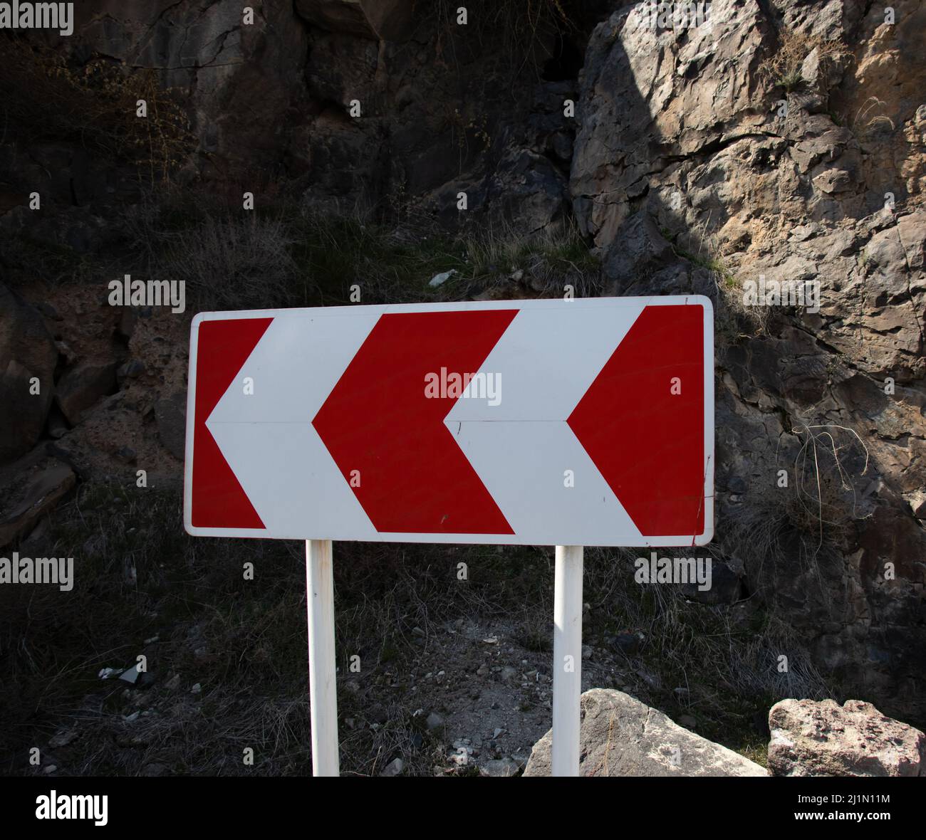 Road signal on the road, left signal Stock Photo - Alamy