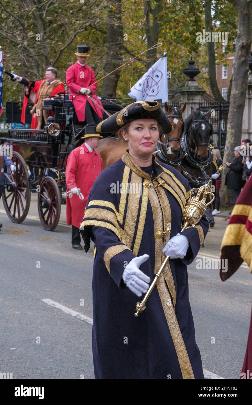Woman dressed in ornate ceremonial robe & hat with gold trim & sceptre ...