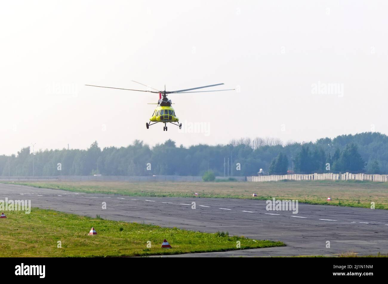 A transport helicopter take off from runway in a small airport Stock ...