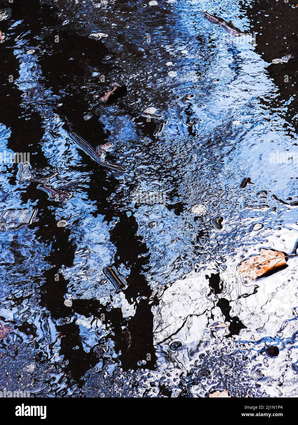 Abstract wet surface in blue with reflections. Blue wet background ...