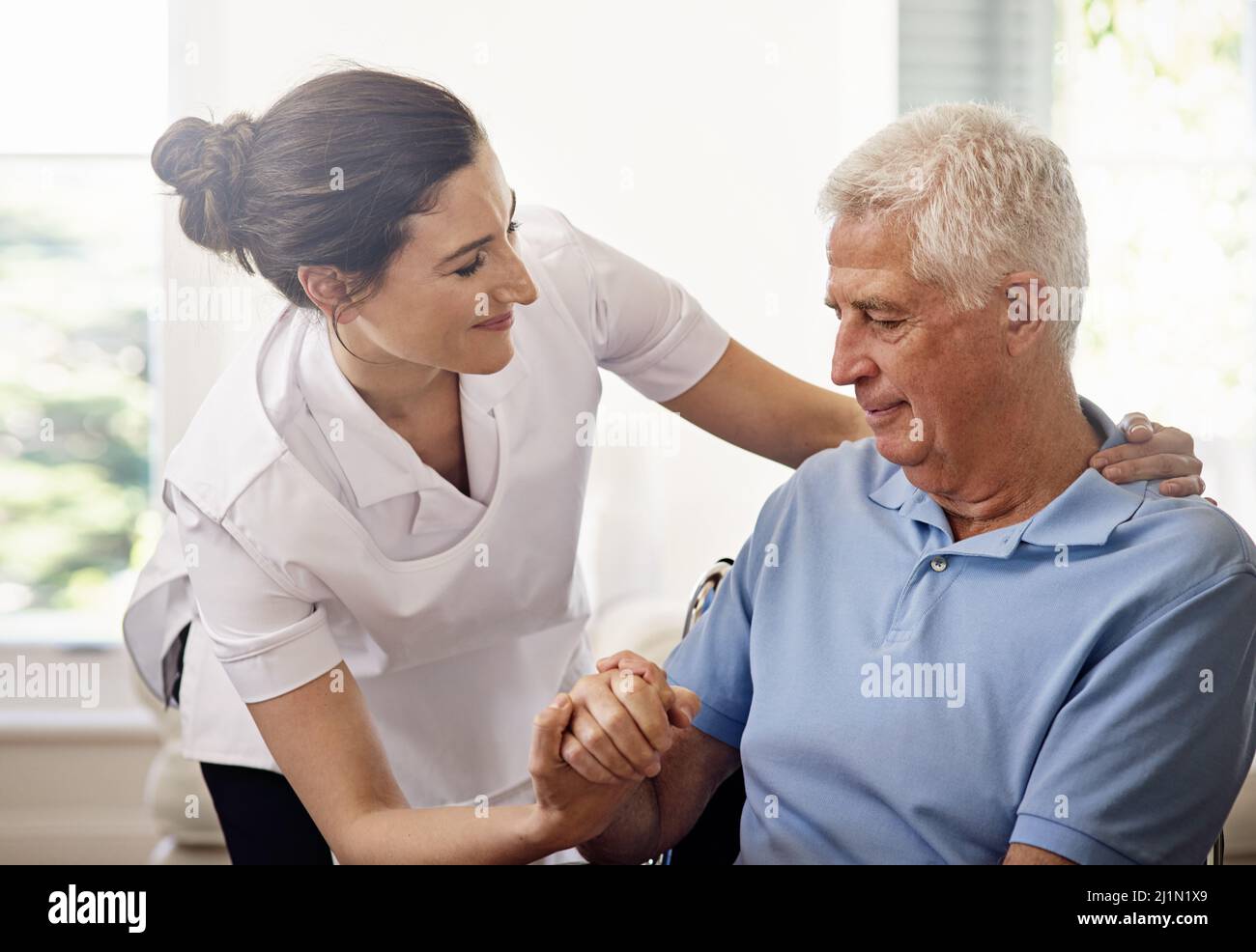 Home care with compassion. Shot of a caregiver helping a senior man in ...