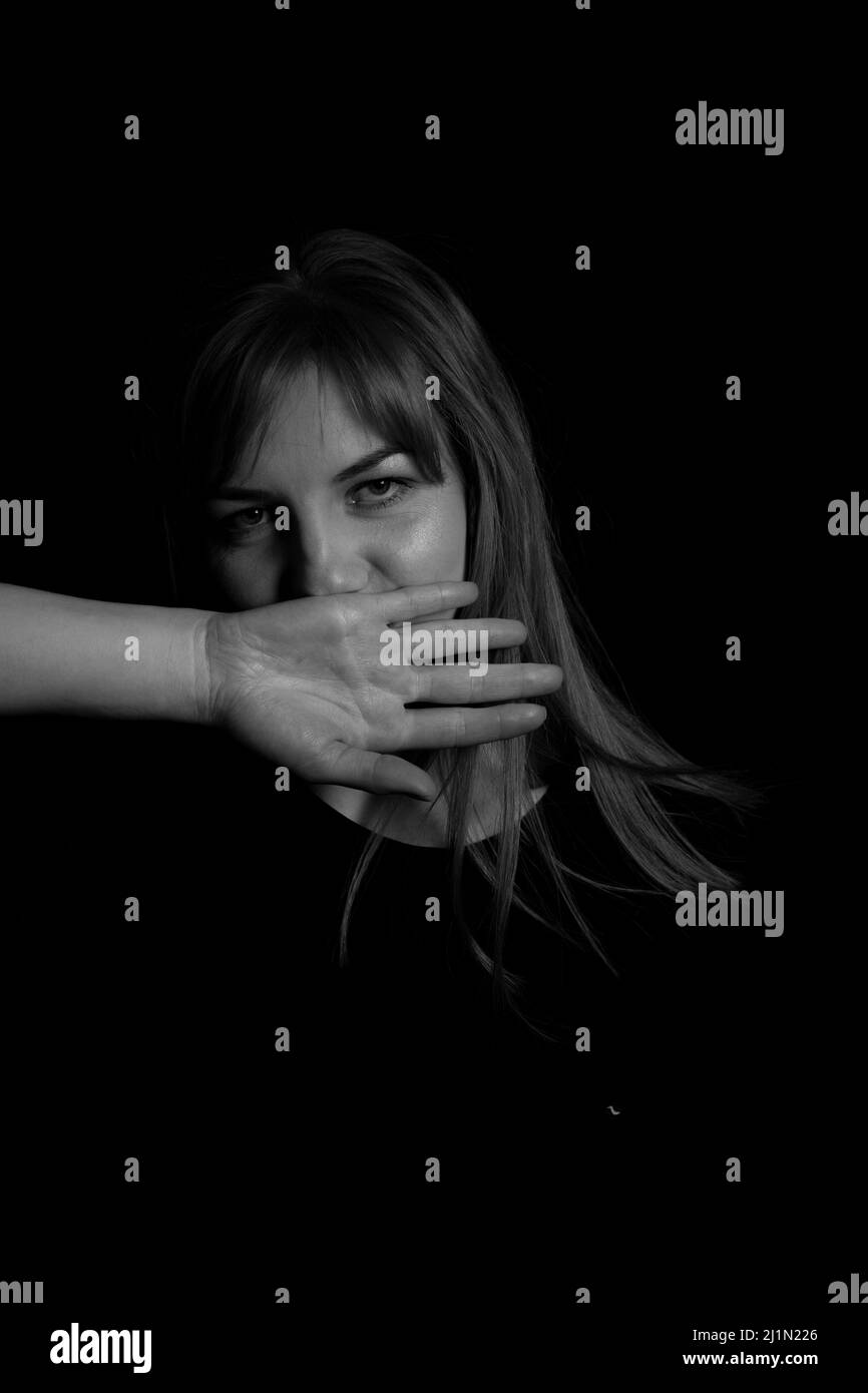 Young beautiful girl covers her face with her hand. Black and white ... Young beautiful girl covers her face with her hand. Black and white ...