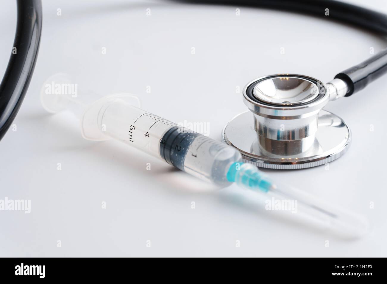 Simple stethoscope and syringe prepared for injection Stock Photo - Alamy