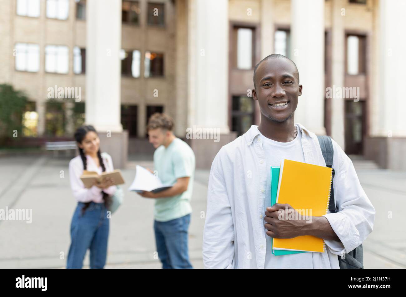Male african american college student with backpack and workbooks ...