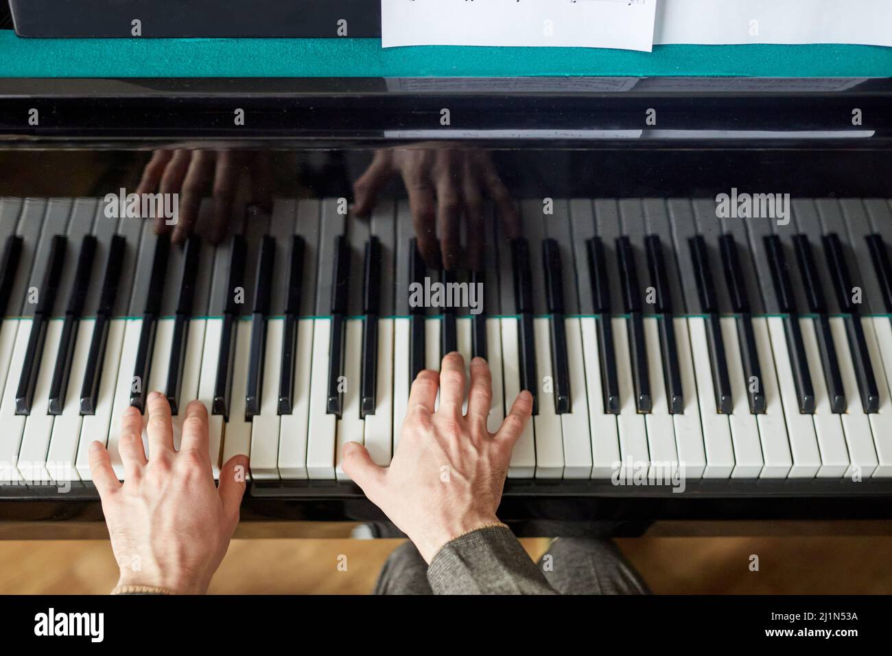 Close-up of male hands pushing on the black and white keys and playing ...