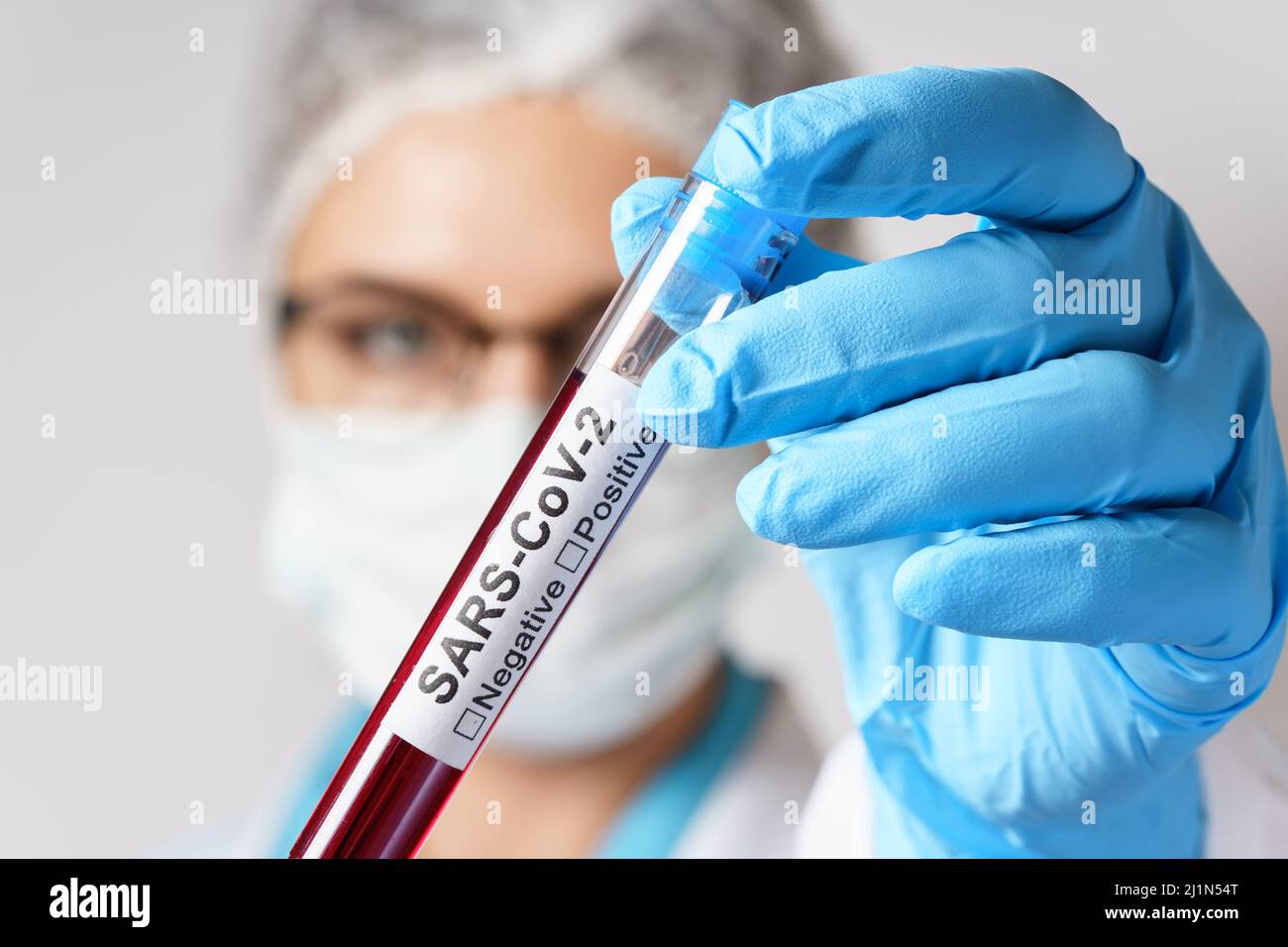 Female doctor is holding a blood sample of the SARS-CoV-2 Stock Photo ...