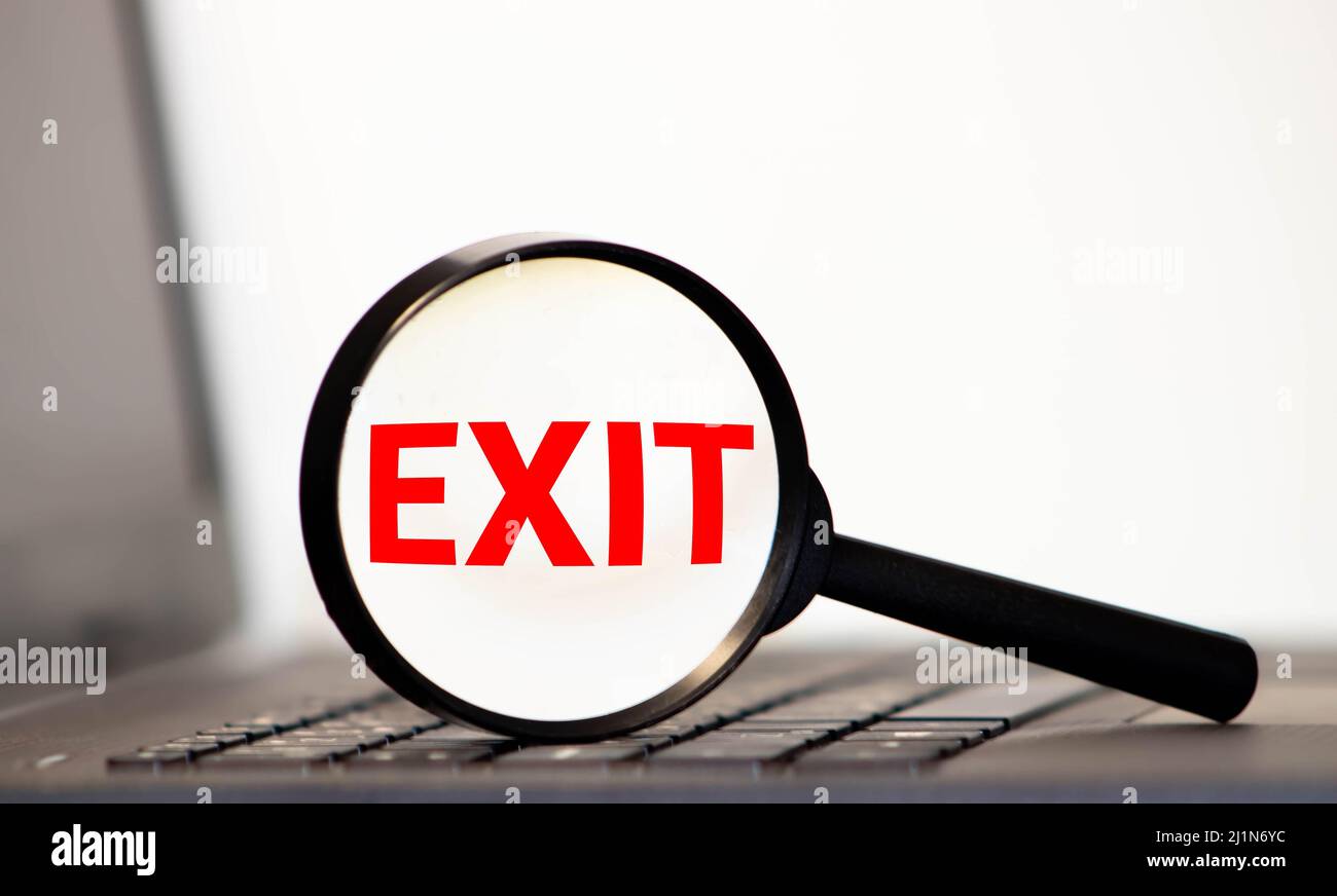 Word EXIT written with white paint on a glass door, modern security ...