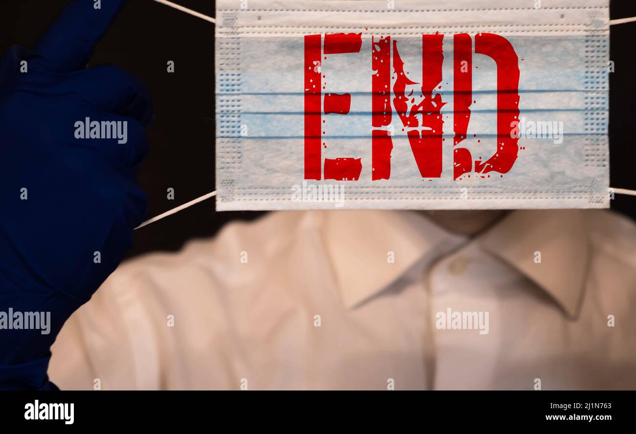 End word glowing in pink neon on a dark brick wall background. Ending ...