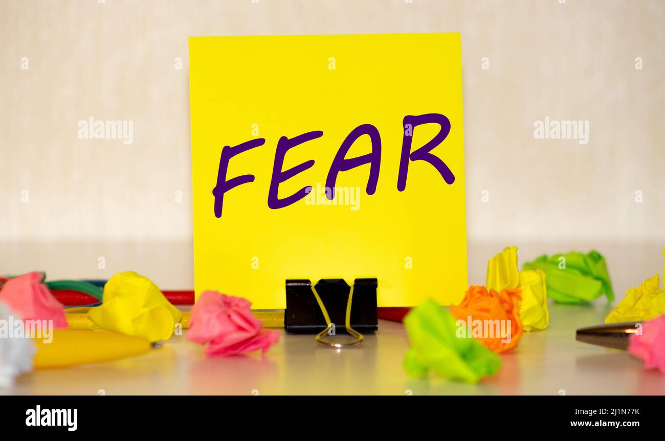 yellow sticky leaf on the wall. inscription marker word fear Stock ...