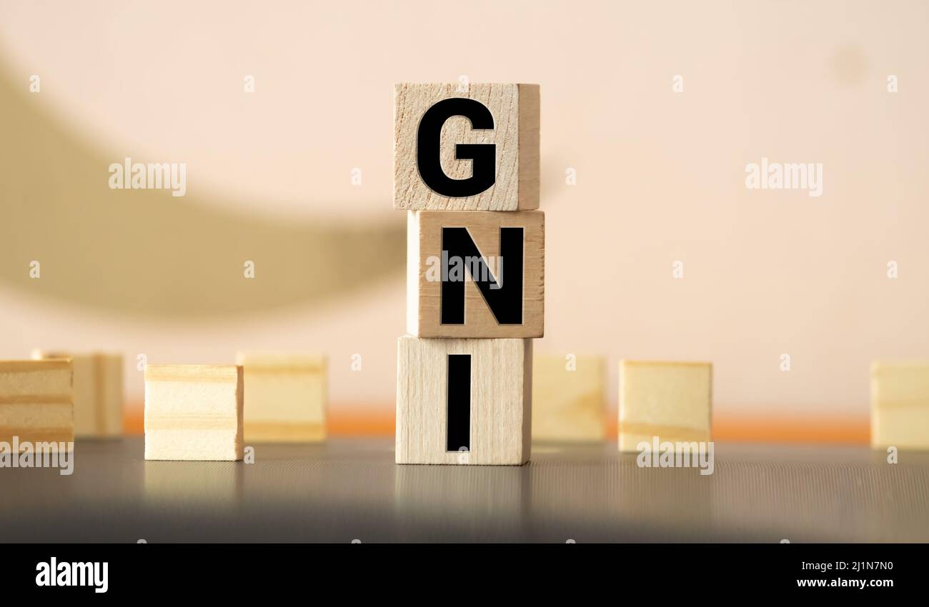 Wooden blocks with the word Gni and up arrow. Gross national income is ...