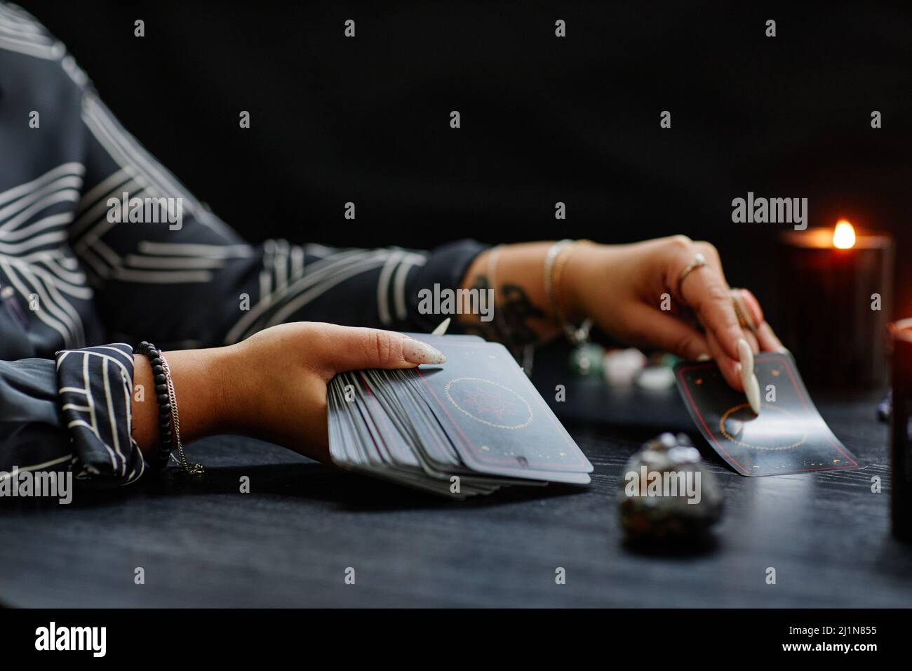 Side view closeup of unrecognizable black woman reading tarot cards ...