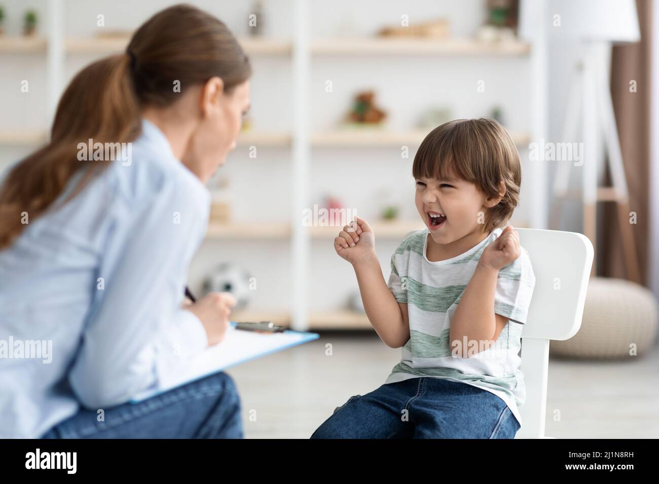 Little furious kid screaming at woman psychologist, denying ...