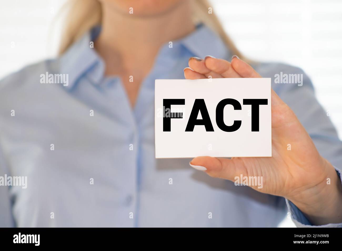 ManBusiness card with the word facts in the hand of a businessman.y ...