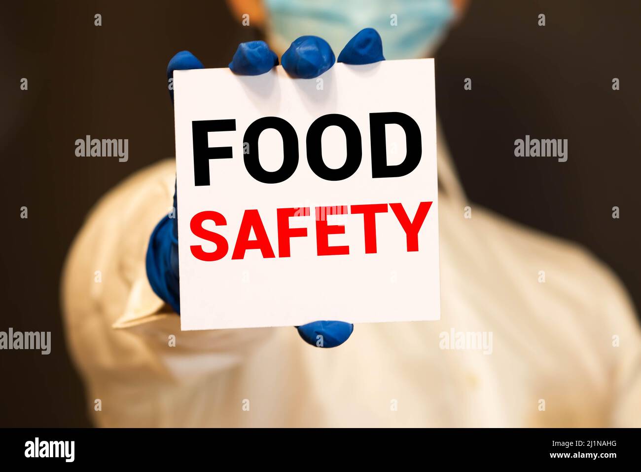 Doctor holding a paper board with text inscription Food Safety Stock ...