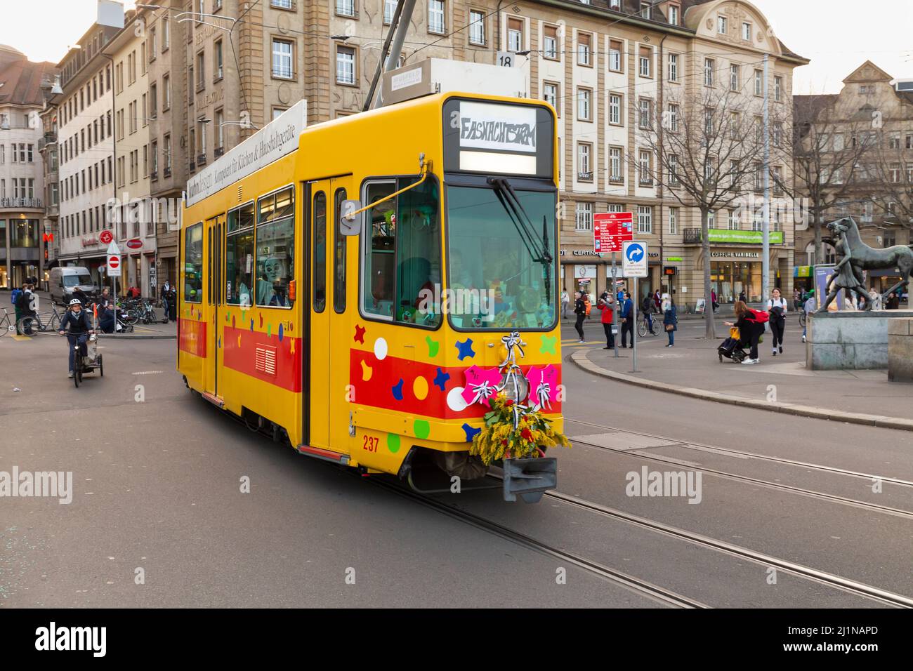 Basel, Switzerland - February 21. Yellow tramway with carnival ...