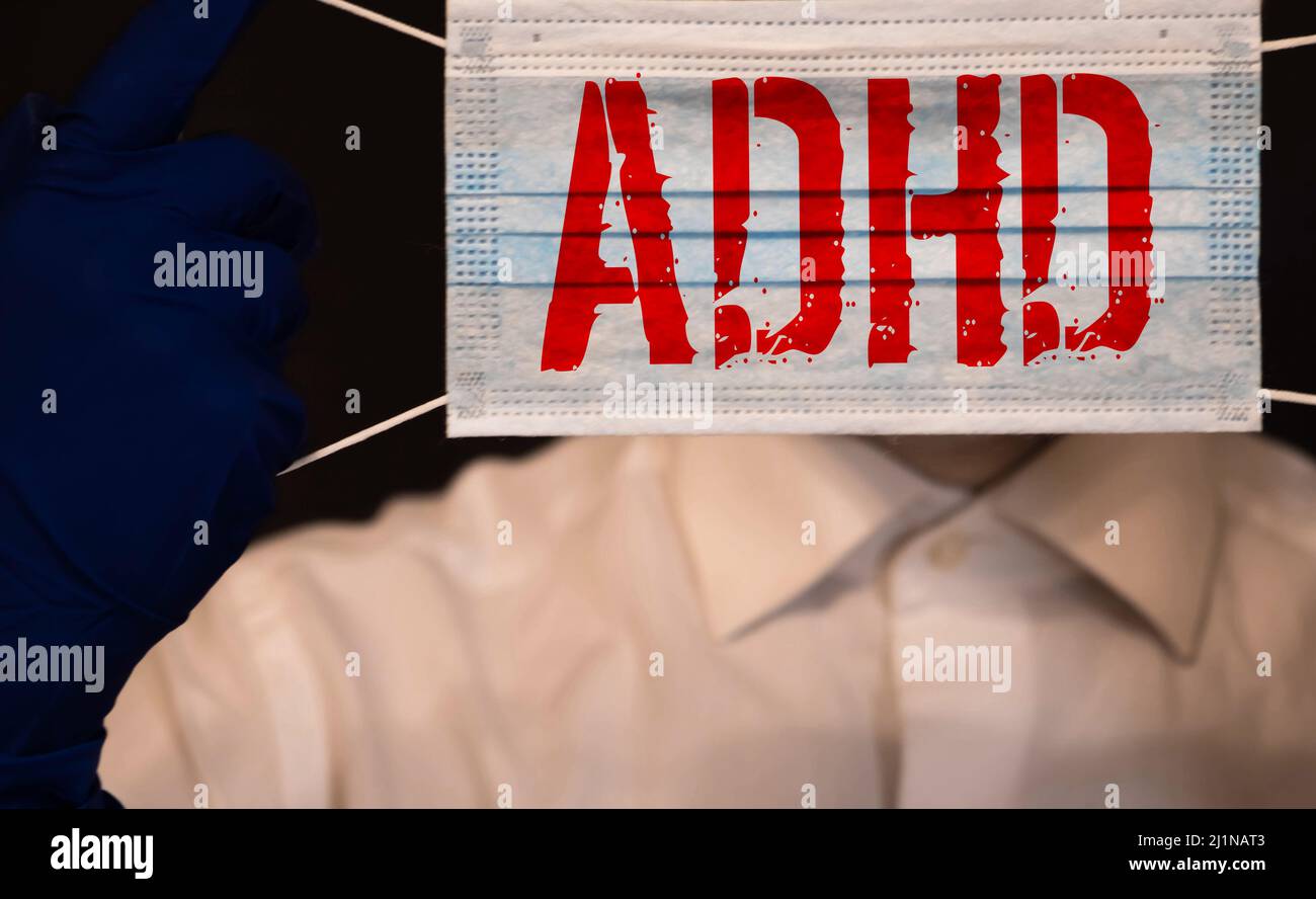 Young boy holds ADHD text written on sheet of paper. ADHD is Attention ...