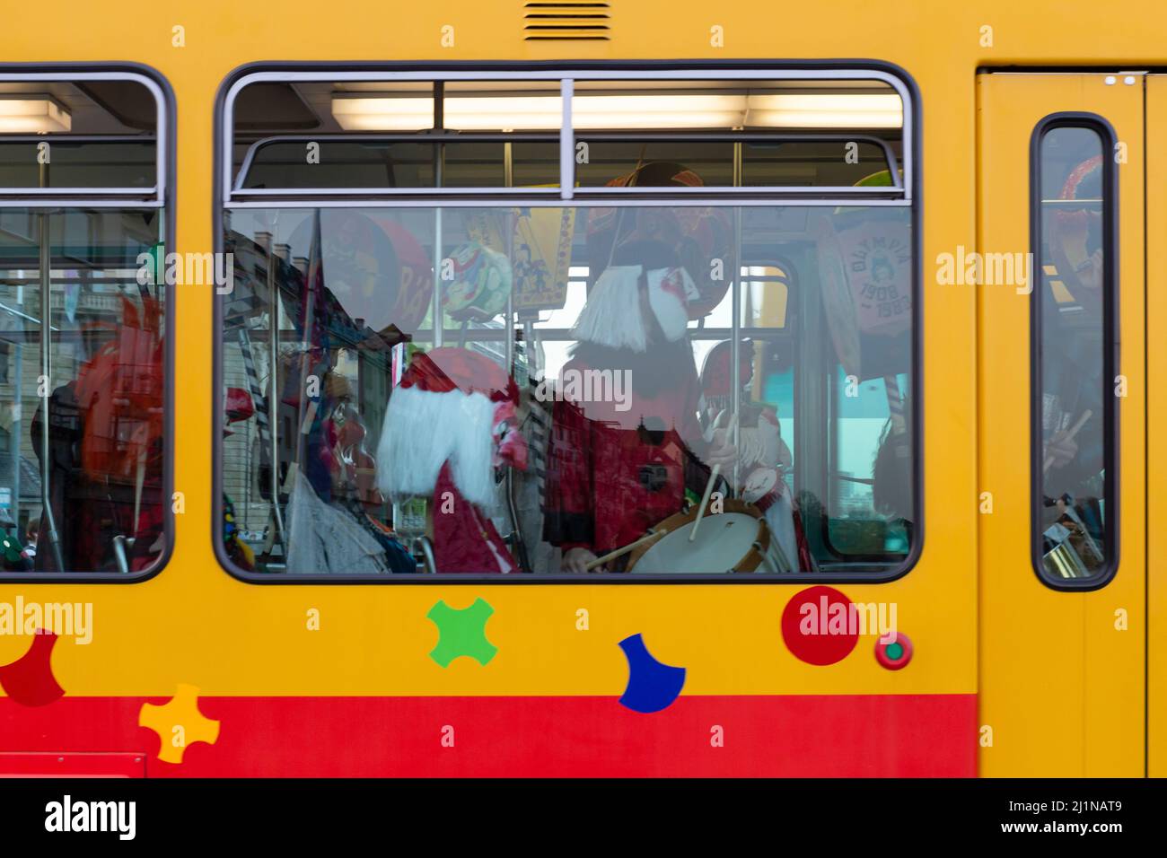 Basel, Switzerland - February 21. Yellow tramway with carnival ...