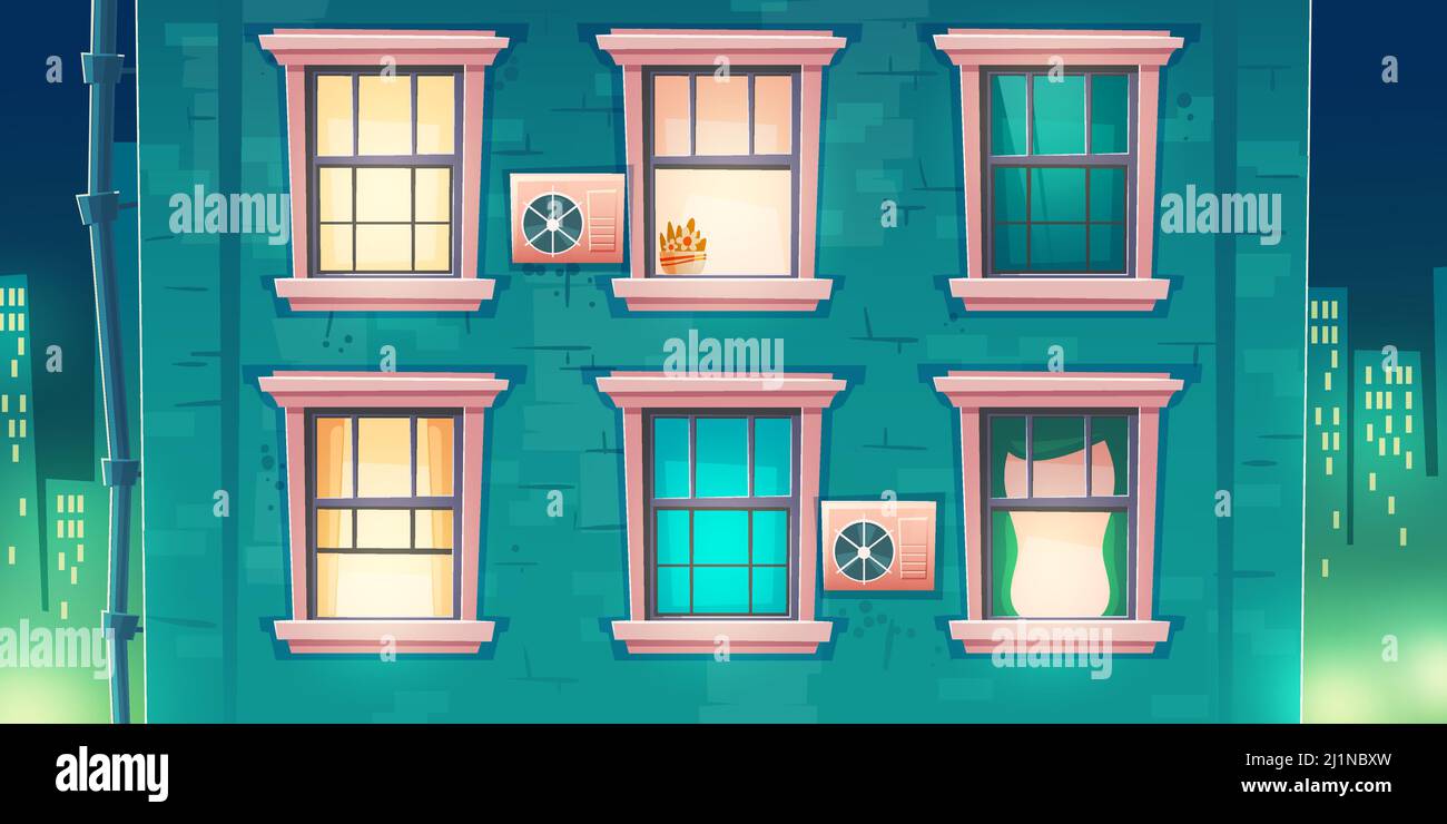 Building facade with brick wall and windows in white frames at night ...