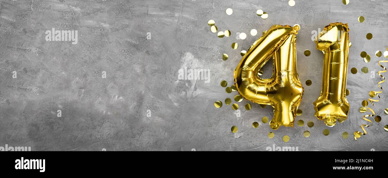 Yellow foil balloon number, number forty one concrete background ...