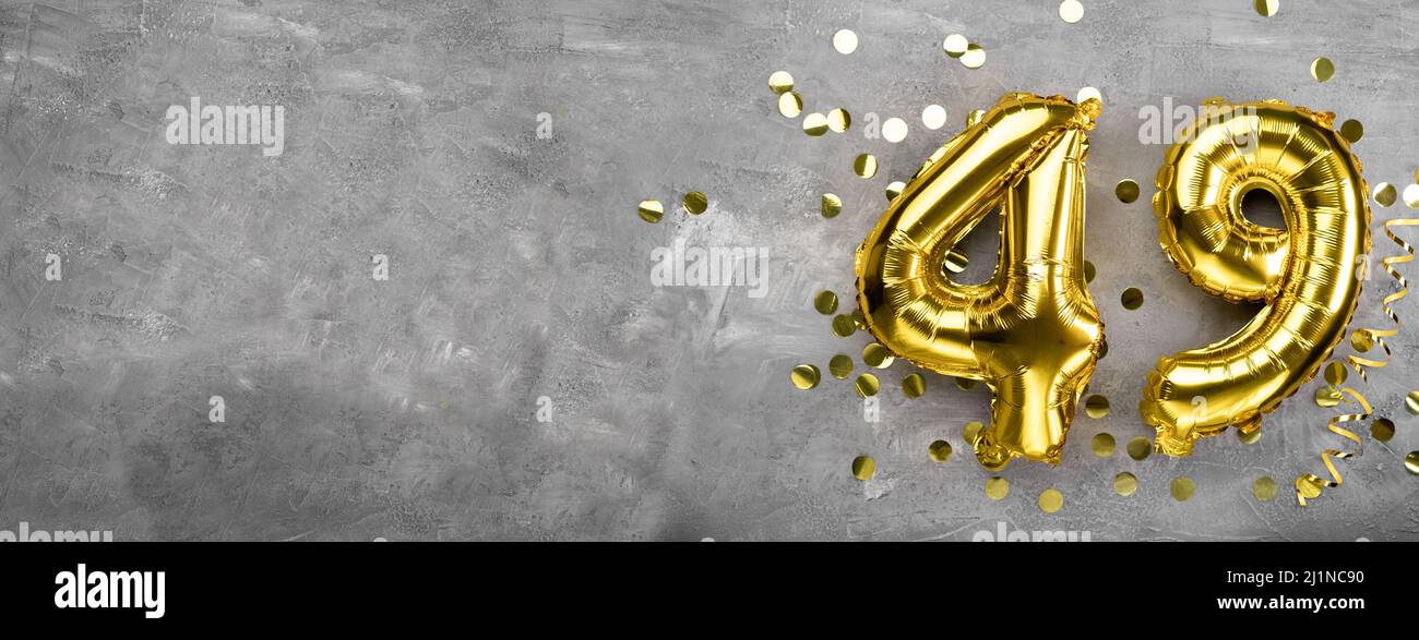 Yellow foil balloon number, number forty nine concrete background ...