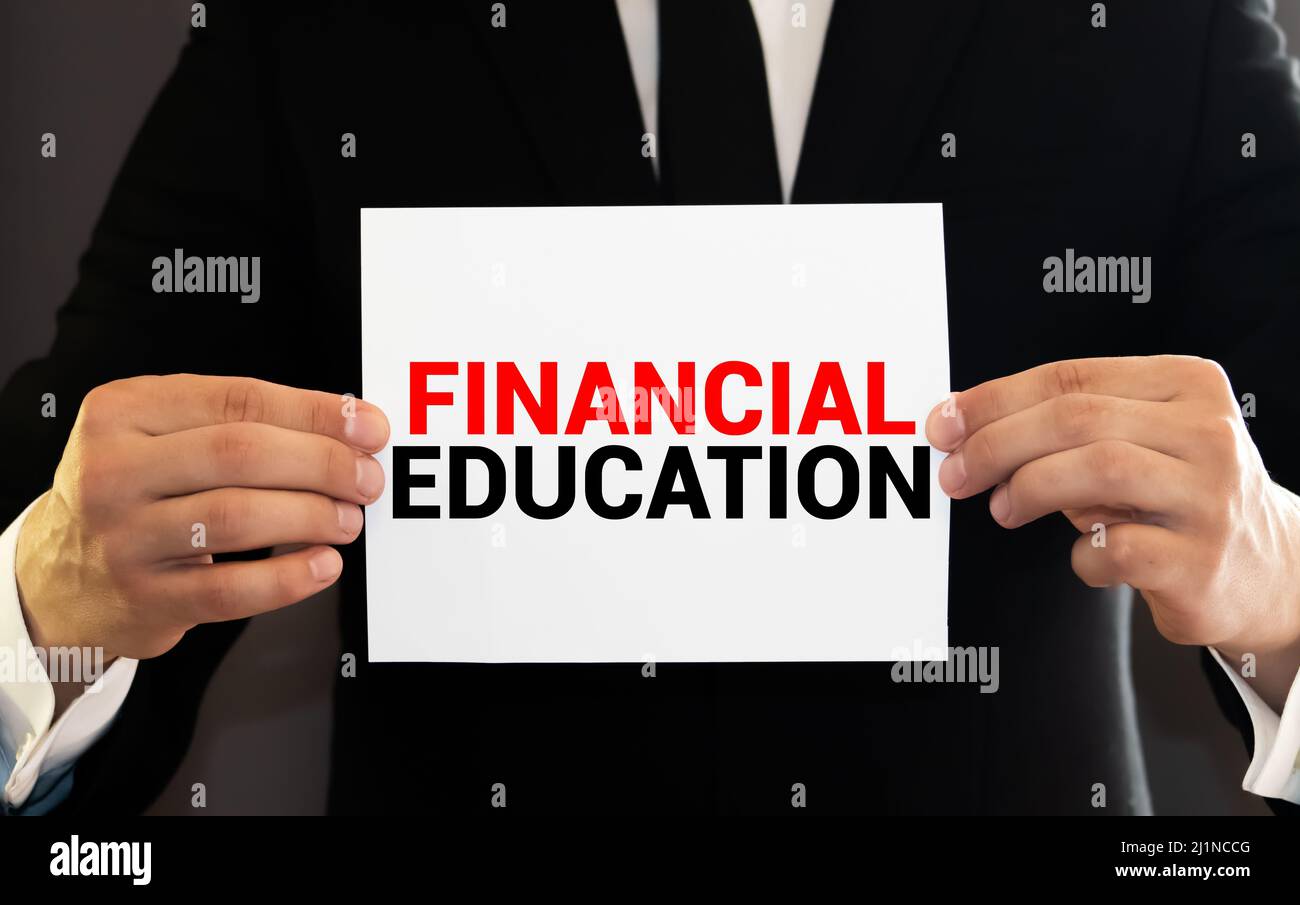 man have a paper with word financial education Stock Photo - Alamy