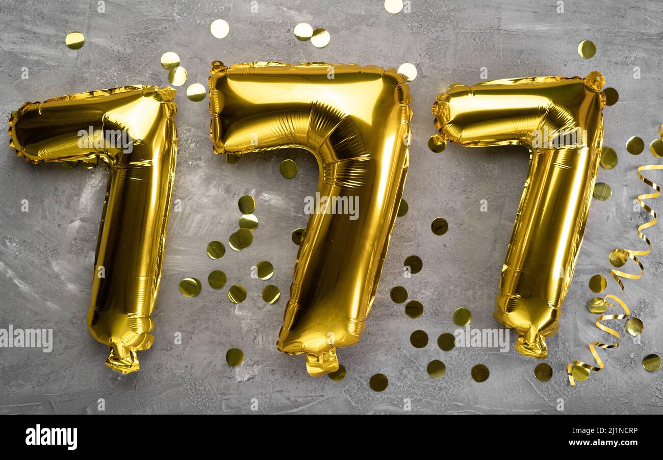 Lucky number seven on a concrete background. yellow balloons three ...