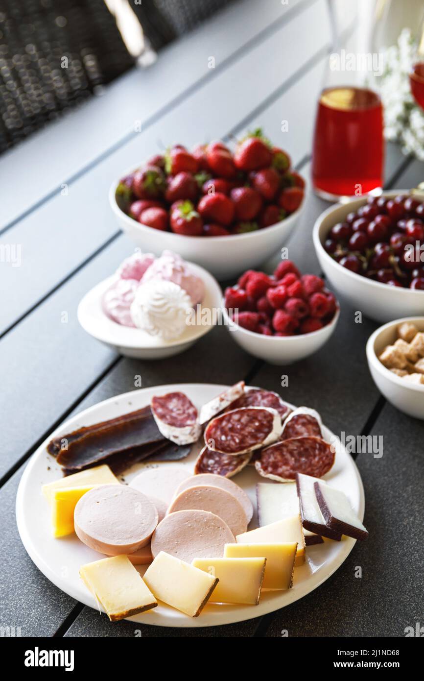 Table full of snacks. Cheese, sausage, salami, meat and berries Stock ...