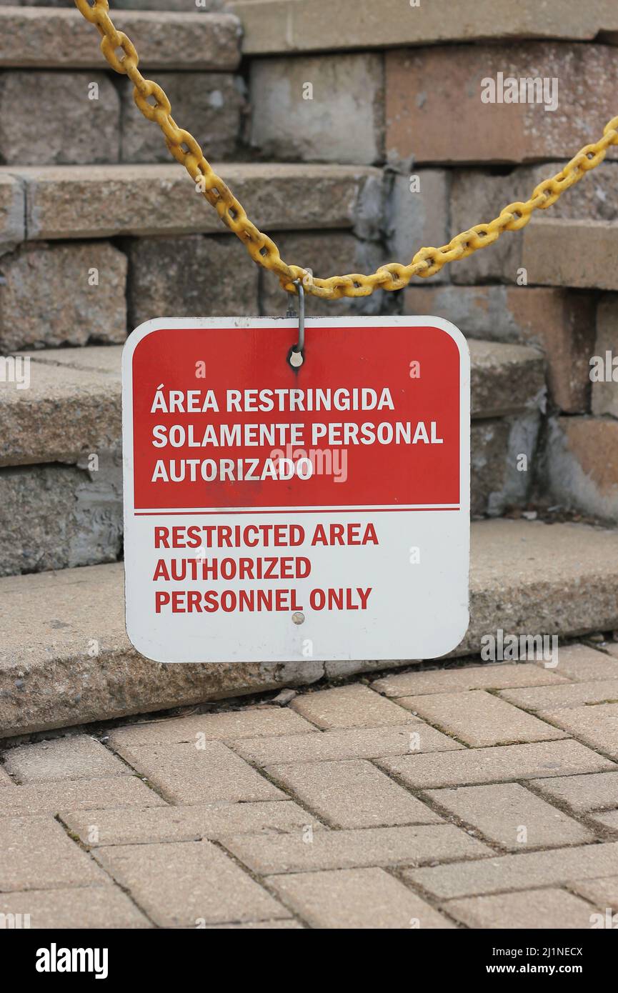 A bilingual information sign that clarifies a Restricted Area ...
