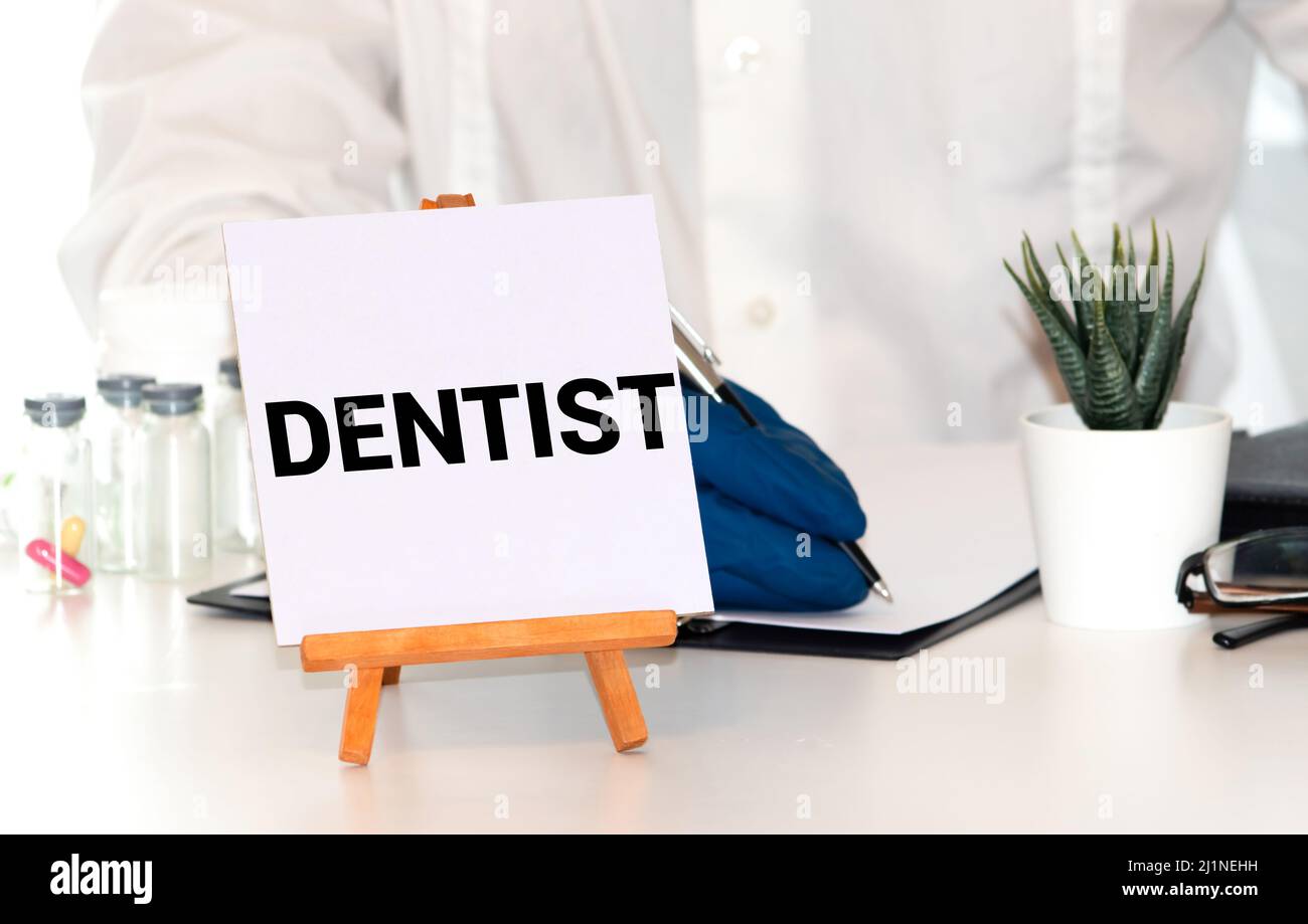 Dentist sign in a wood, medical word concept Stock Photo - Alamy