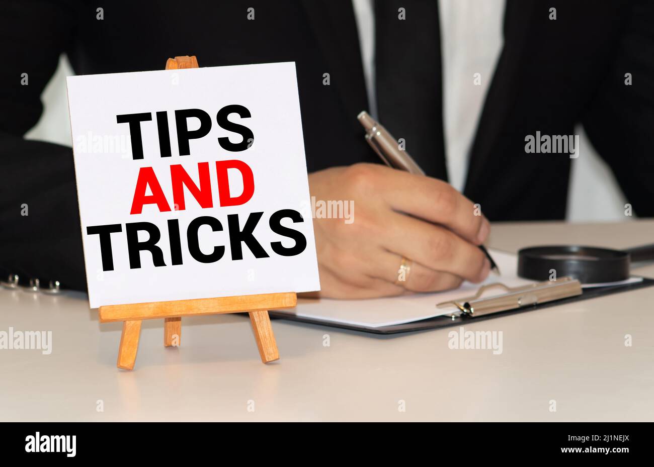 Tips and tricks on note book with hand on desk Stock Photo - Alamy
