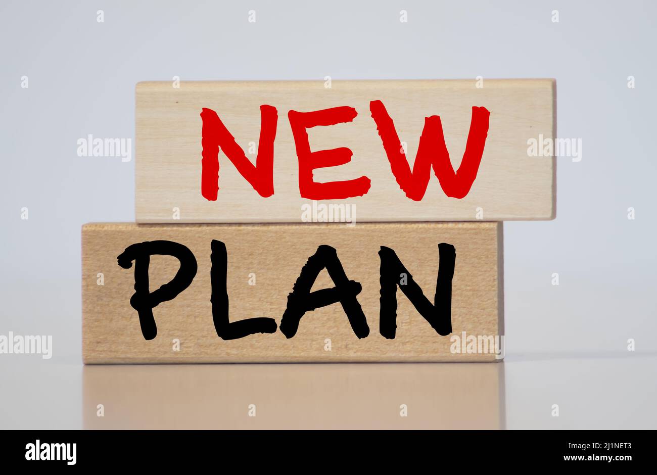 new plan text on wooden blocks isolated on light grey background ...