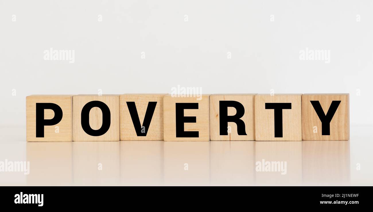 Poverty word written on wood block. Poverty text on wooden table for ...