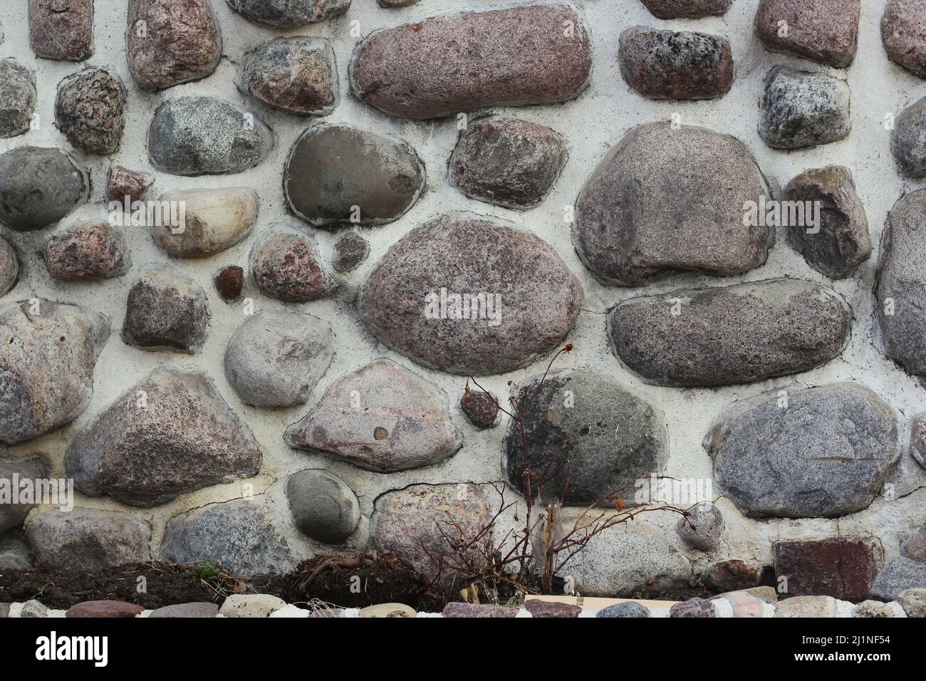 A natural granite stone wall made with round boulders Stock Photo - Alamy