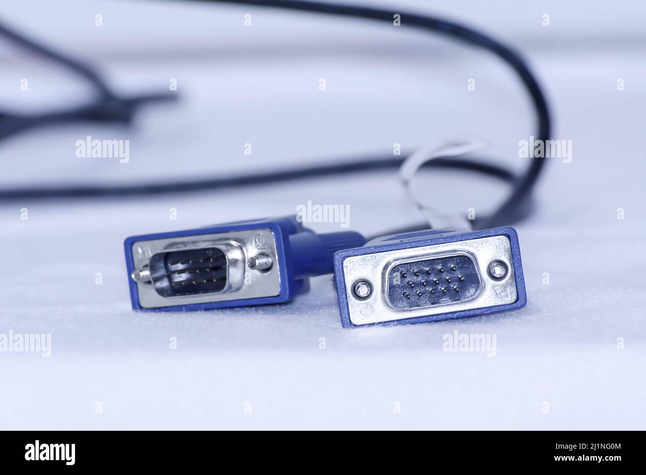 A couple of blue male VGA cable connector wires isolated on a white ...