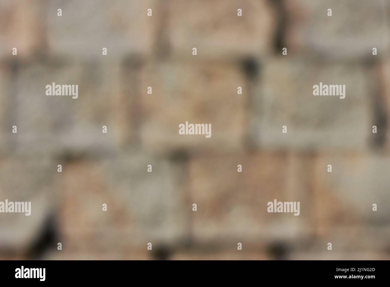 A dreamy blurry view of a masonry natural stone wall Stock Photo - Alamy