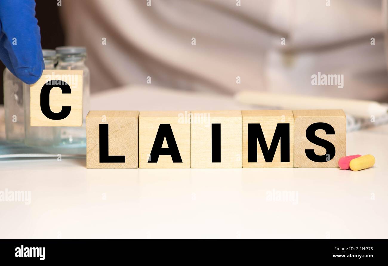claims word written on wood block. claims text on wooden table for your ...