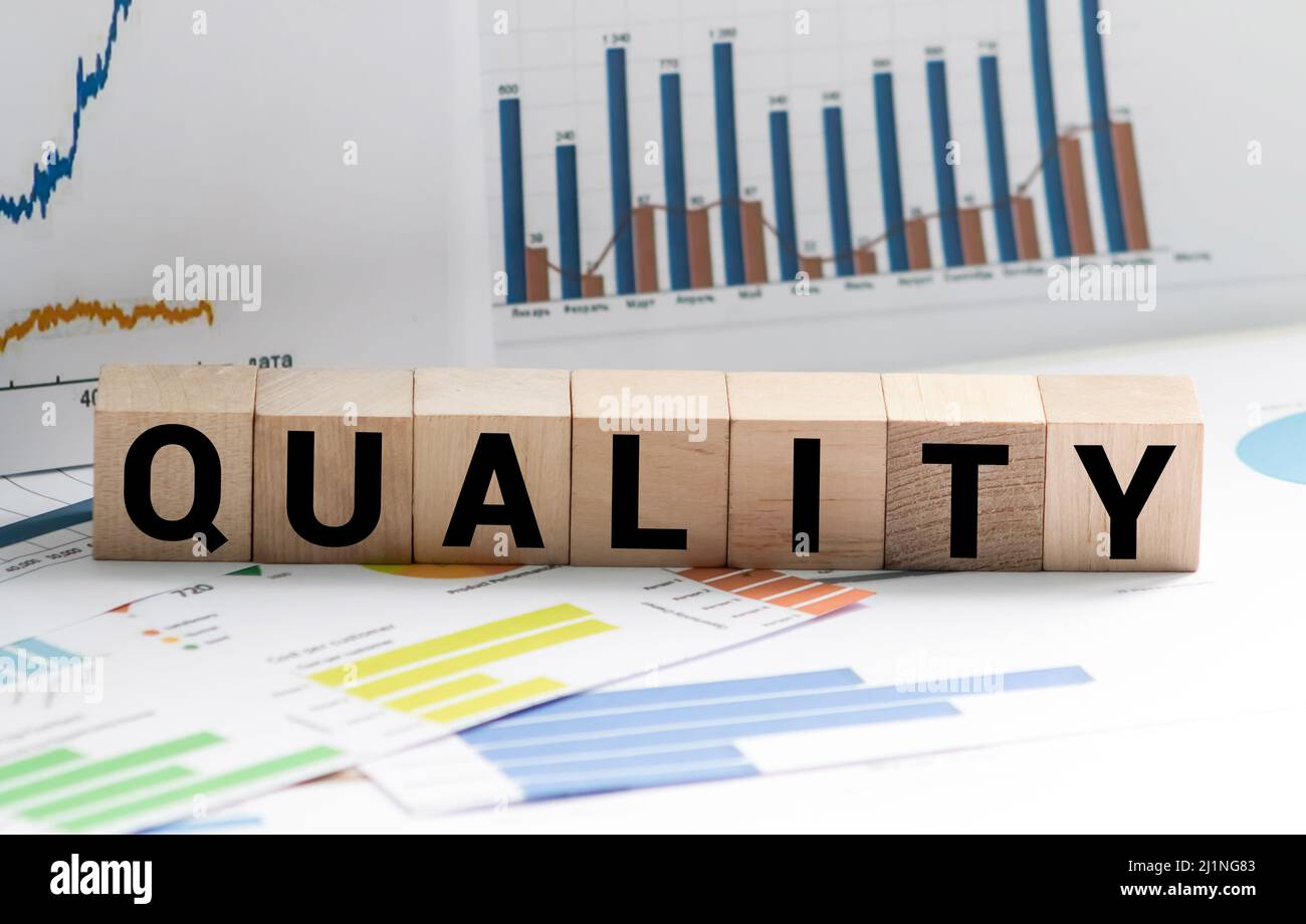 QUALITY word written on wood block, concept Stock Photo - Alamy