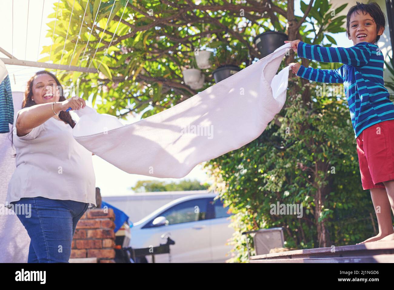Hes mommys little helper. Portrait of a mother and son holding a towel ...