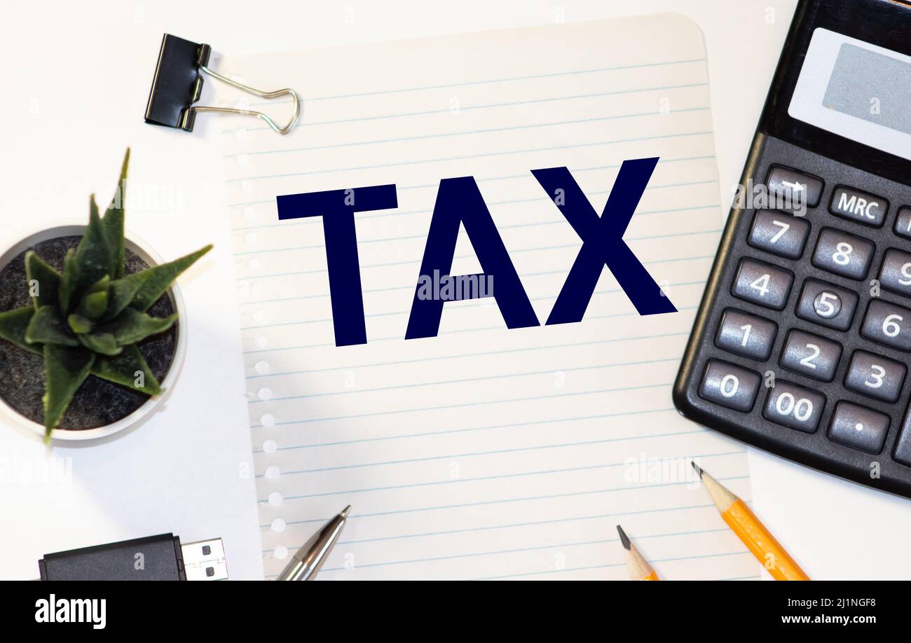 TAX Business team hands at work with financial reports and a laptop ...