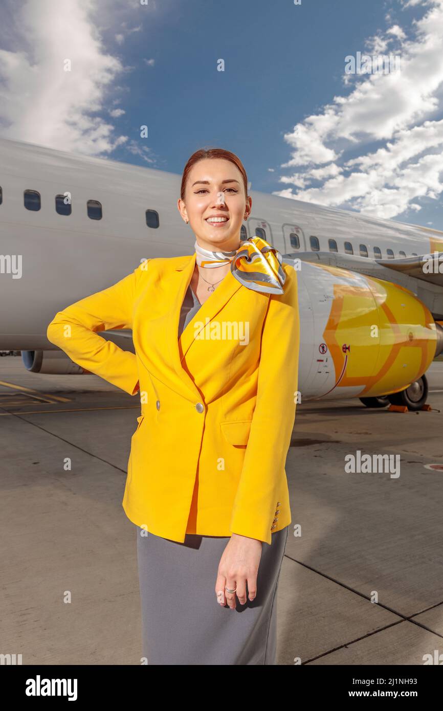 Joyful flight attendant standing outdoors at airfield Stock Photo - Alamy