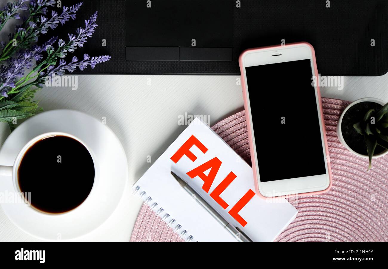 The word fall hand drawn on white paper sign dry brown autumn leafs ...