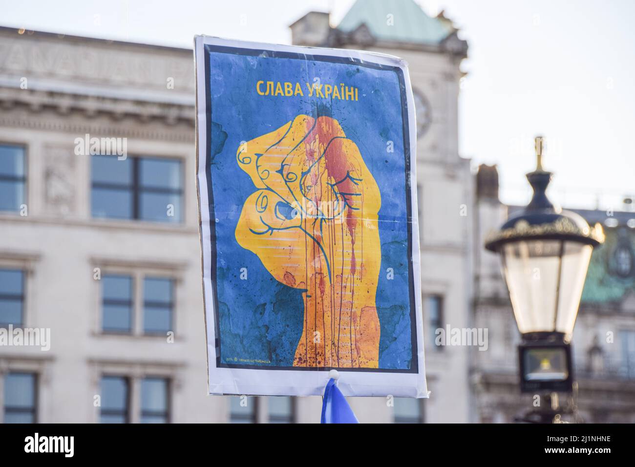 London, UK. 26th March 2022. A protester holds a 'Slava Ukraini' (Glory ...