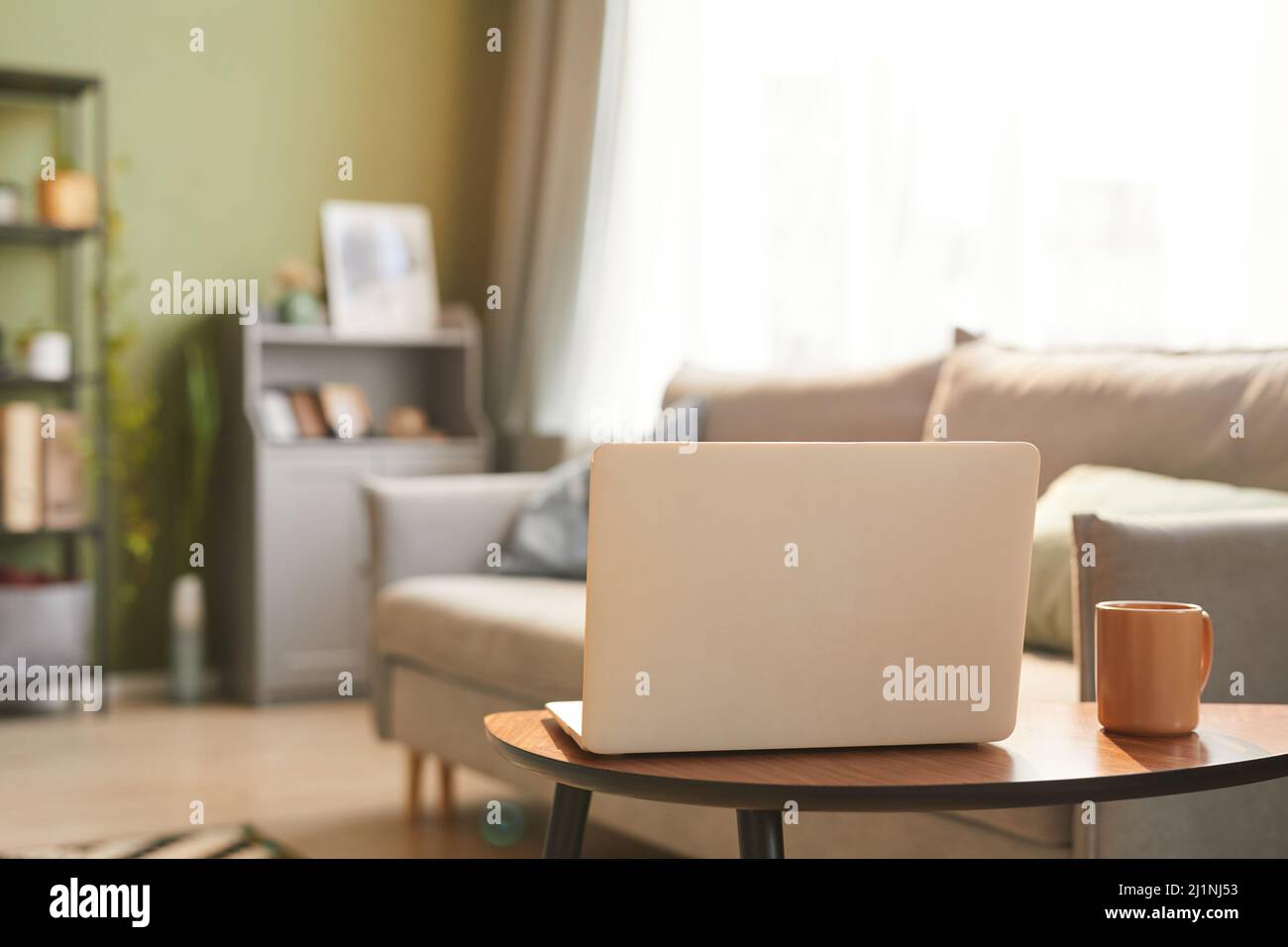 Minimal background image of opened laptop in cozy living room interior ...